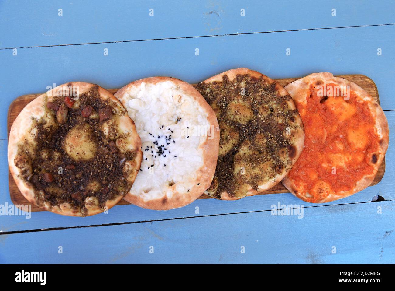 A set of Lebanese maouajanet or manaqish, zaatar, cheese, and lahm b ...