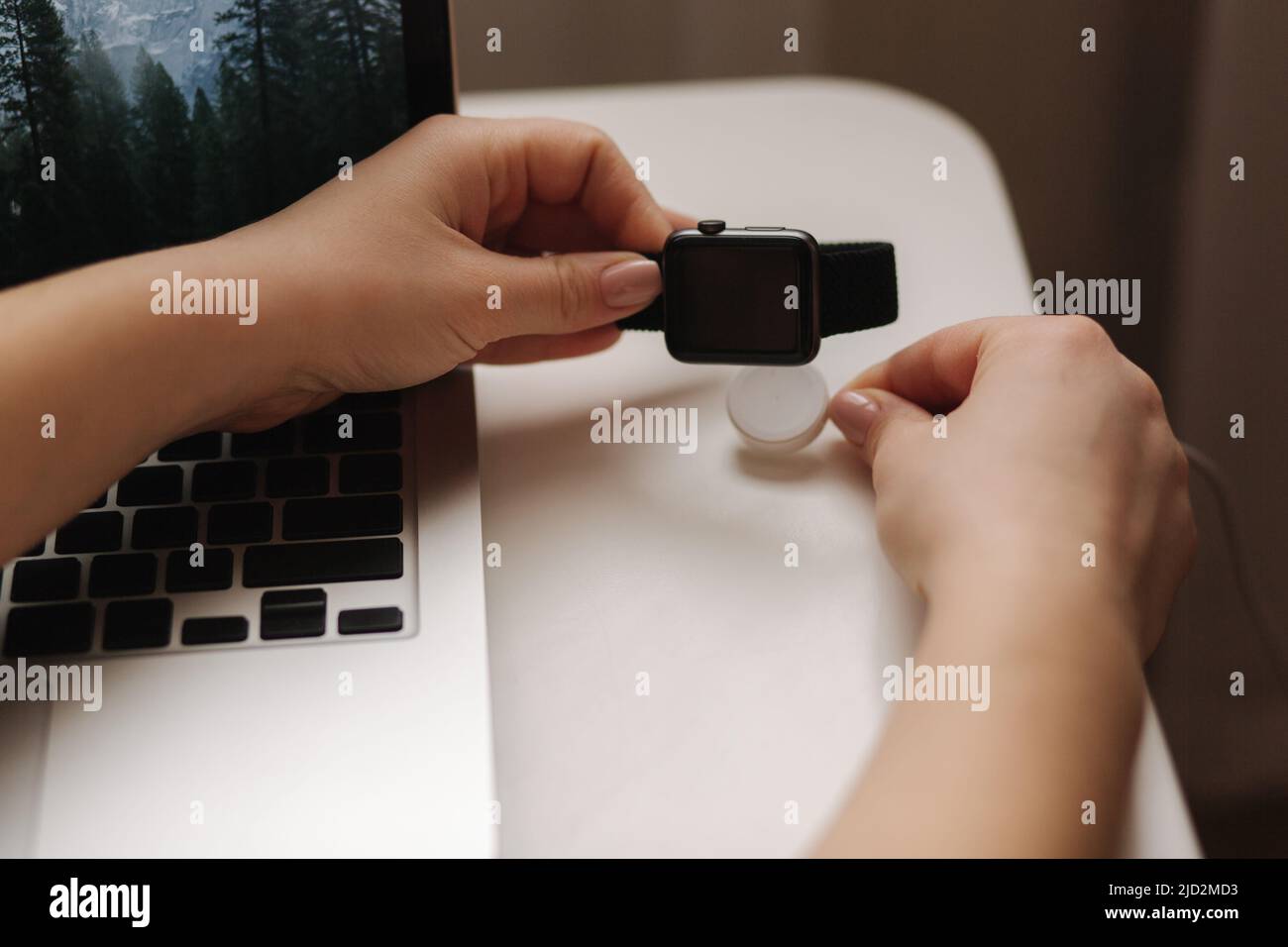 Female hand put smart watch on wireless charging with on-screen ...