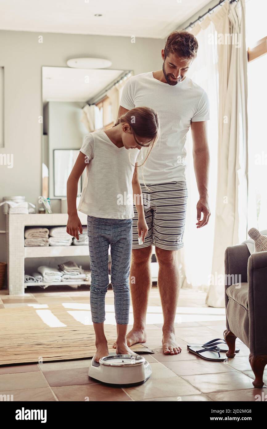 His little girl is growing up fast. Shot of a father helping his little ...