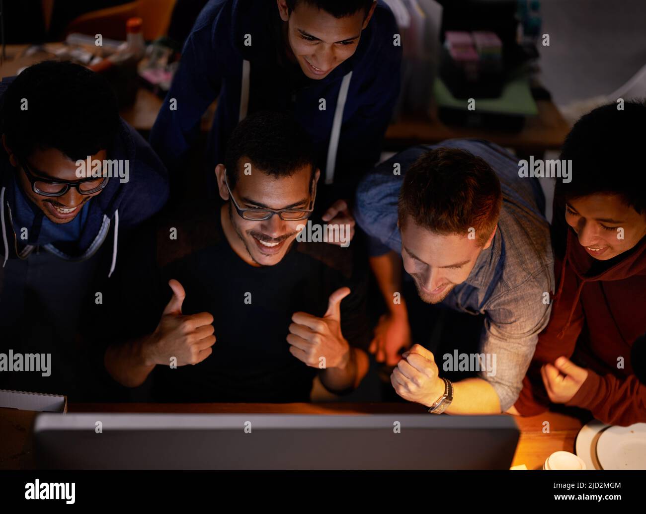 Were gonna win boys. Shot of a group of young man cheering at a monitor ...