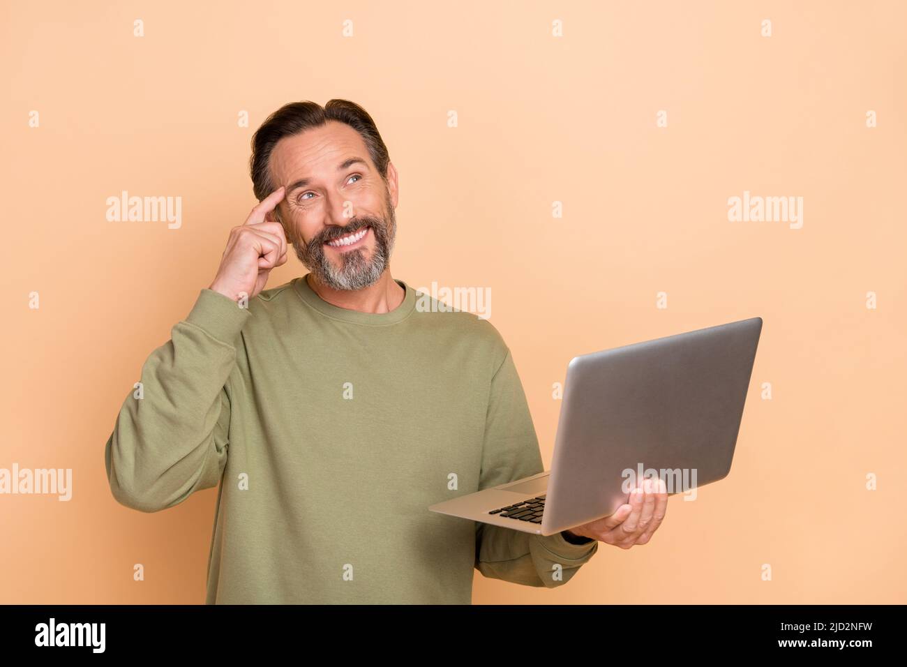 Portrait of attractive minded smart clever cheerful man using laptop ...