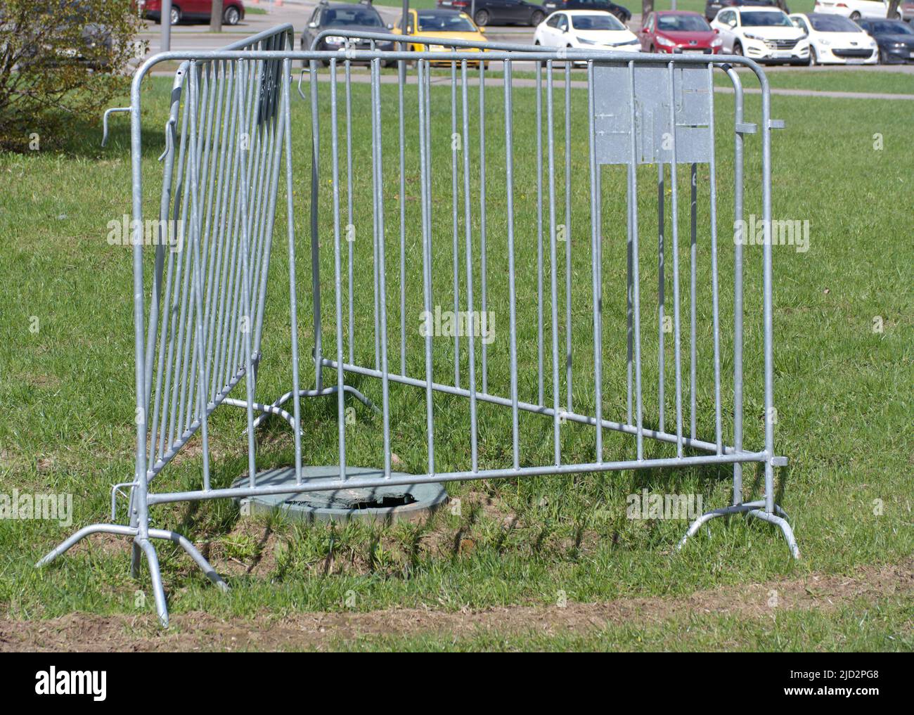 fence around manhole in park at dry sunny summer day Stock Photo - Alamy