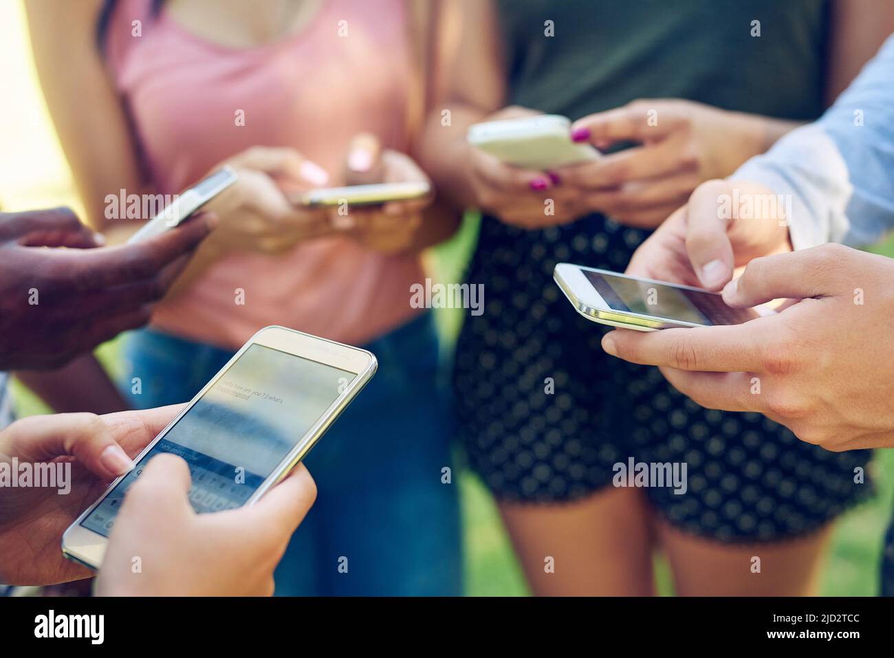 Mobile millennials. Cropped shot of a group of friends using their ...
