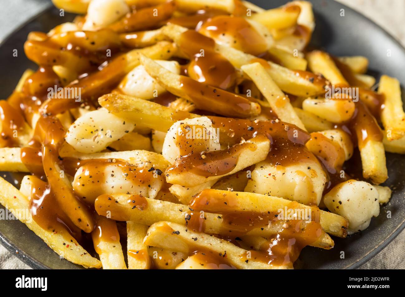 Homemade Cheesey Poutine French Fries with Gravy and Cheese Curds Stock ...