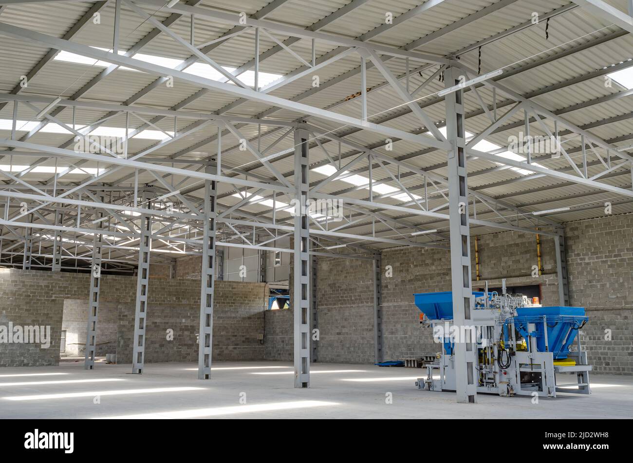 Interior of paving plant. Empty industrial premises. Machine that ...