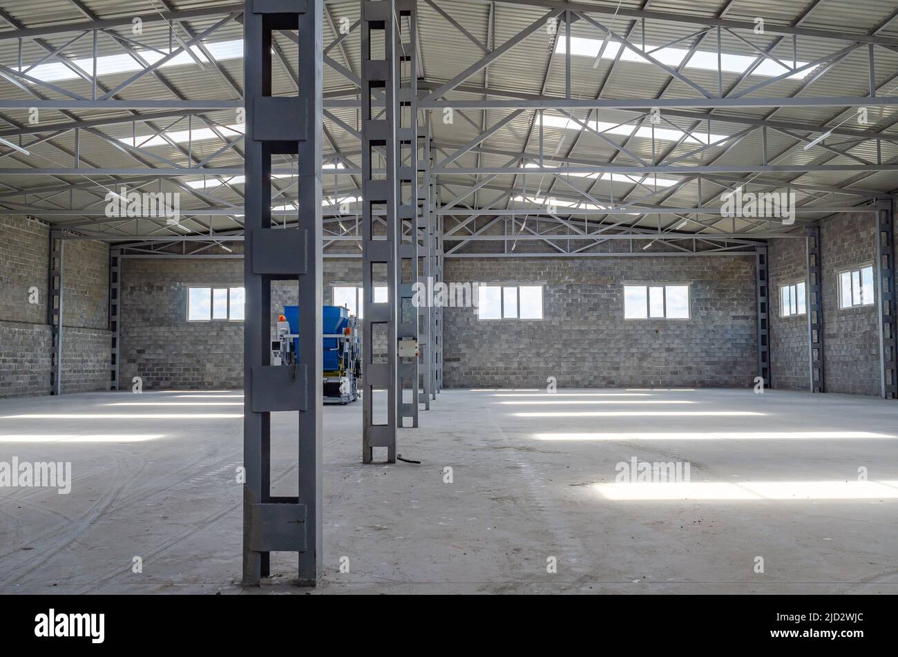 Ceiling of large factory building with artificial lighting. Industrial ...