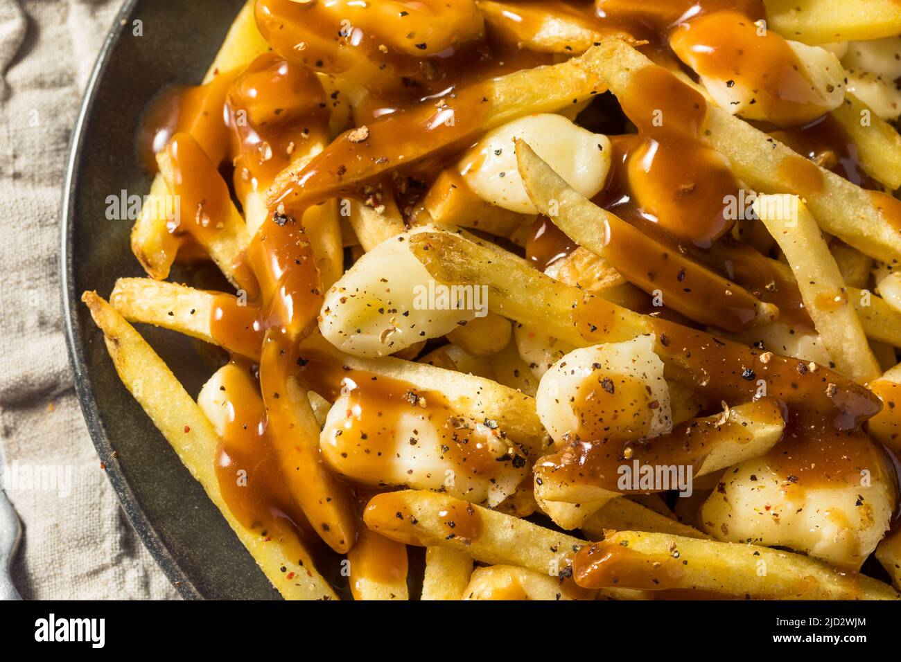 Homemade Cheesey Poutine French Fries with Gravy and Cheese Curds Stock ...