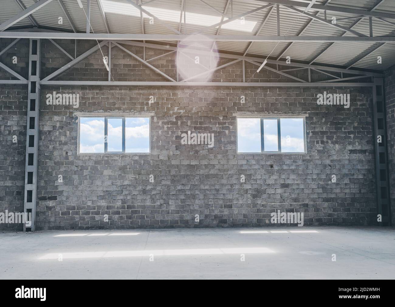 Empty warehouse. Brick walls, windows in walls and ceiling. Modern ...