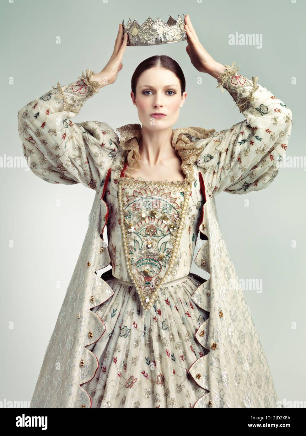 Long live the Queen. Shot of queen holding a crown over her head Stock ...