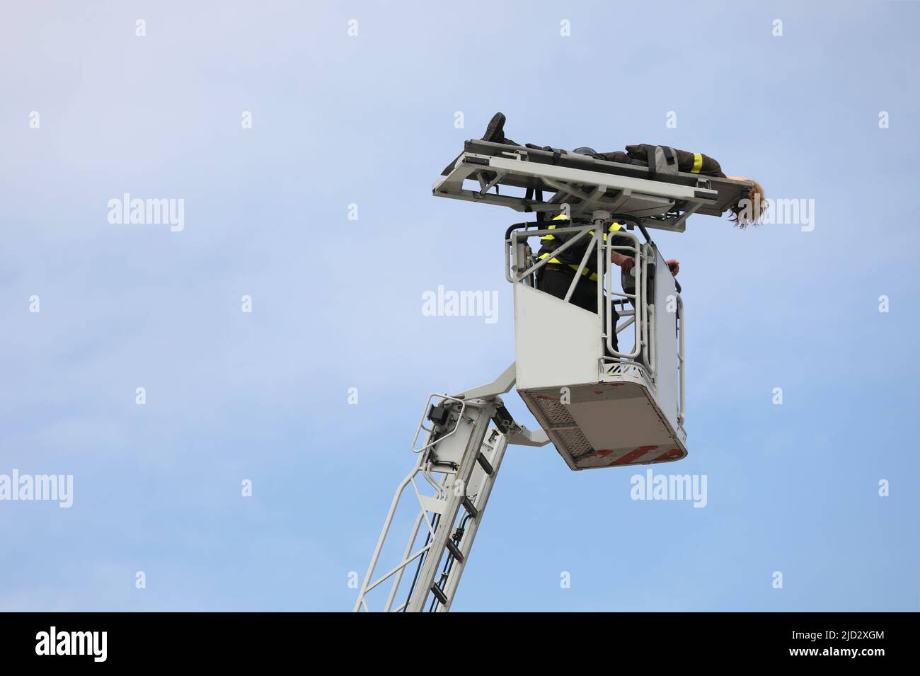 Firefighter on the aerial platform and the injured person on the ...
