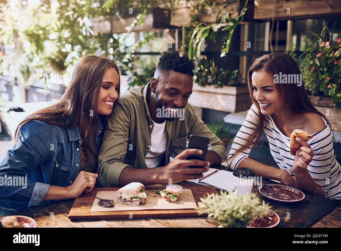 Three men eating together restaurant hi-res stock photography and ...
