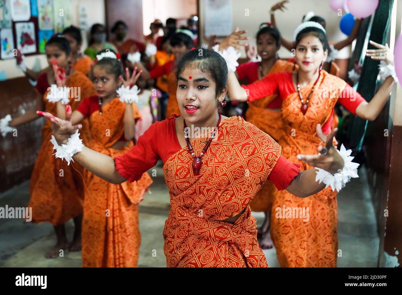 Girls from the dance group in traditional dress greet guests at the ...