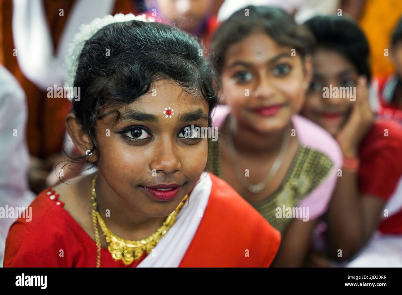 Girls from the dance group in traditional dress greet guests at the ...