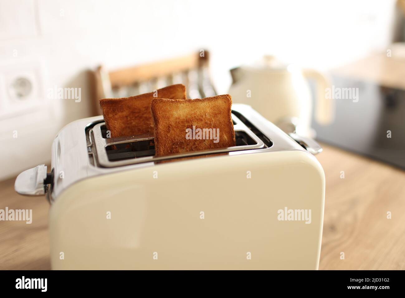 Toasted bread and toaster for breakfast. Modern white toaster and ...