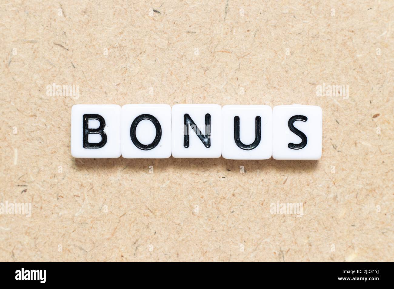 White tile alphabet letter with word bonus on wood background Stock ...