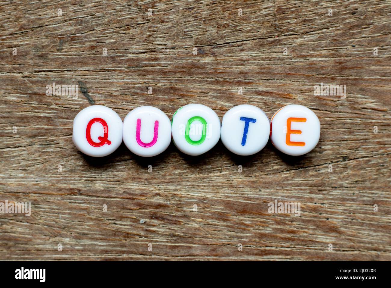 White bead with color letter in word quote on wood background Stock ...