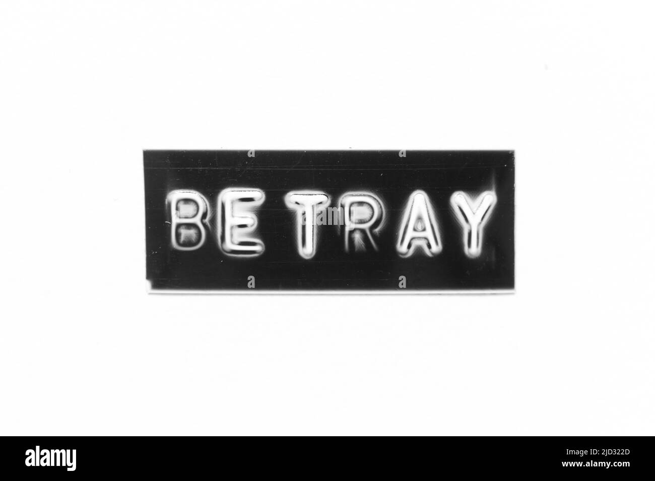 Black color banner that have embossed letter with word betray on white ...