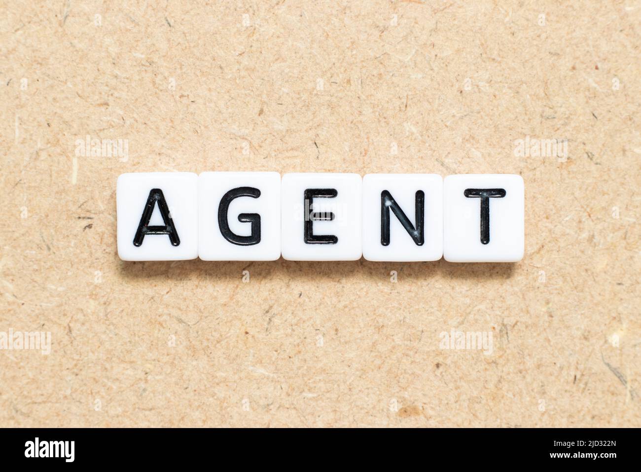 White tile alphabet letter with word agent on wood background Stock ...