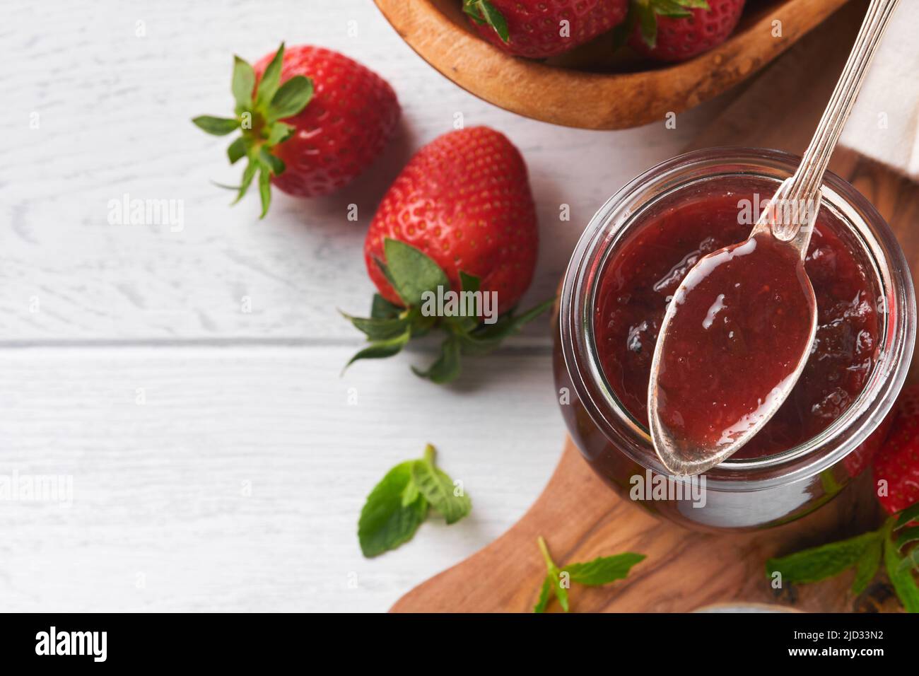 Strawberry jam. Strawberry jam in glass jar with fresh berries plate on ...