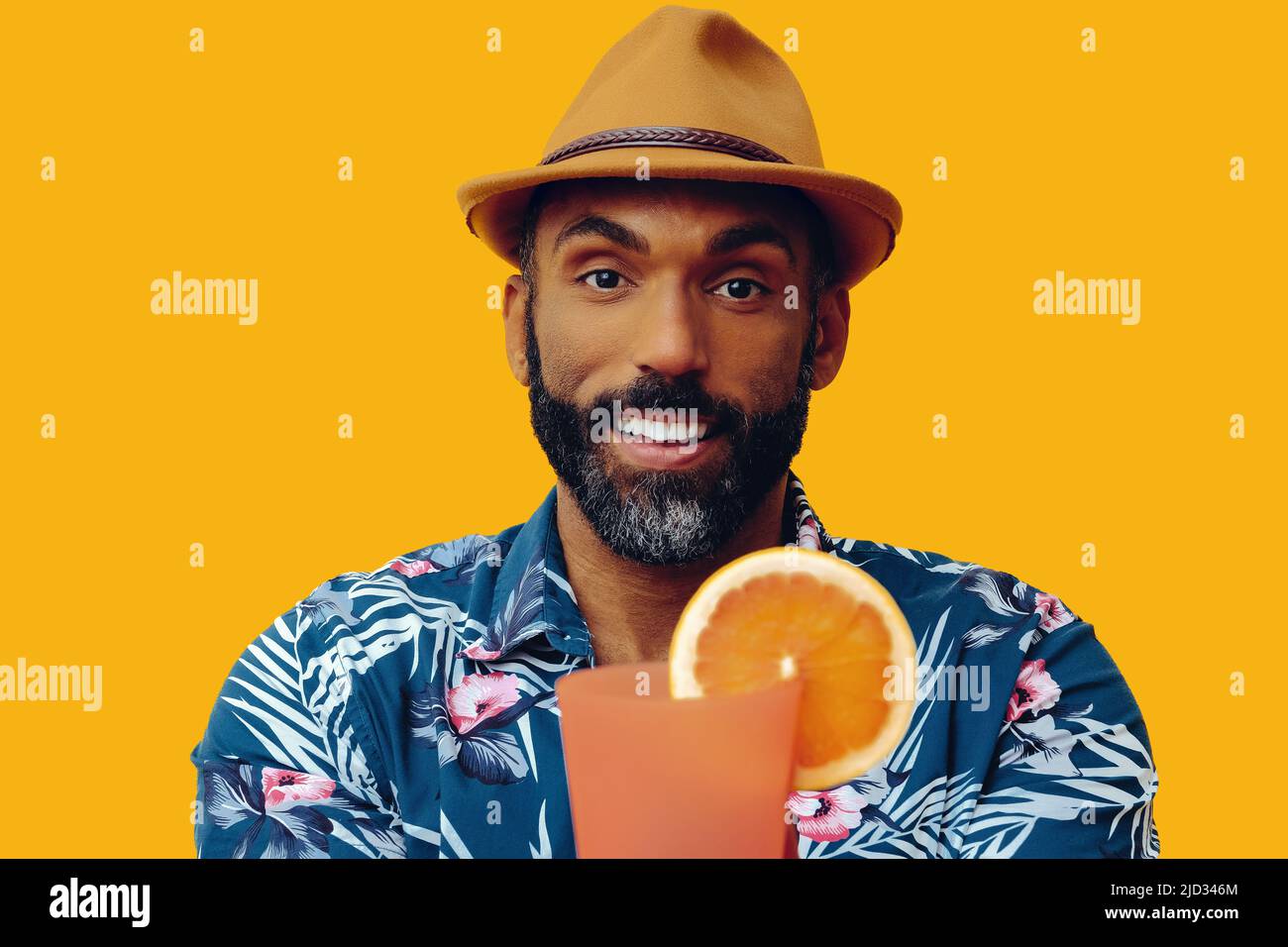 happy bearded mid adult african american man wearing Hawaiian shirt and hat smiling offering ...