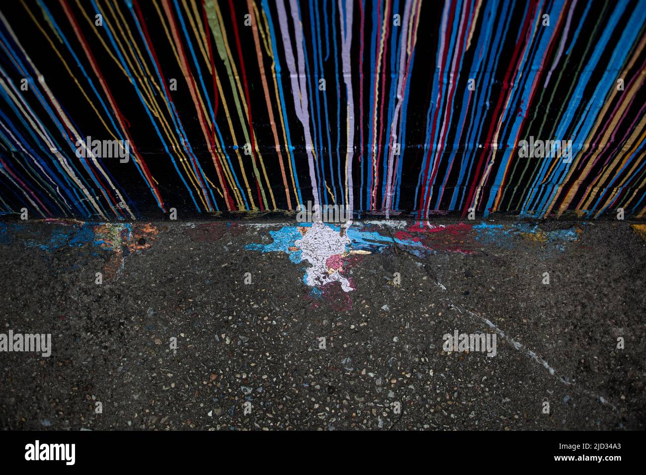 Multiple colored Paint drips streaks down a brick wall Stock Photo - Alamy