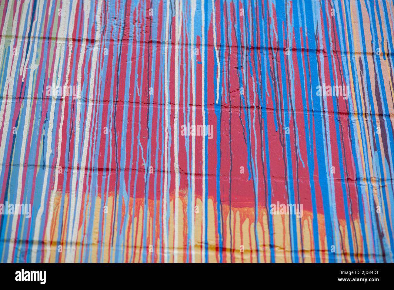 Multiple colored Paint drips streaks down a brick wall Stock Photo - Alamy