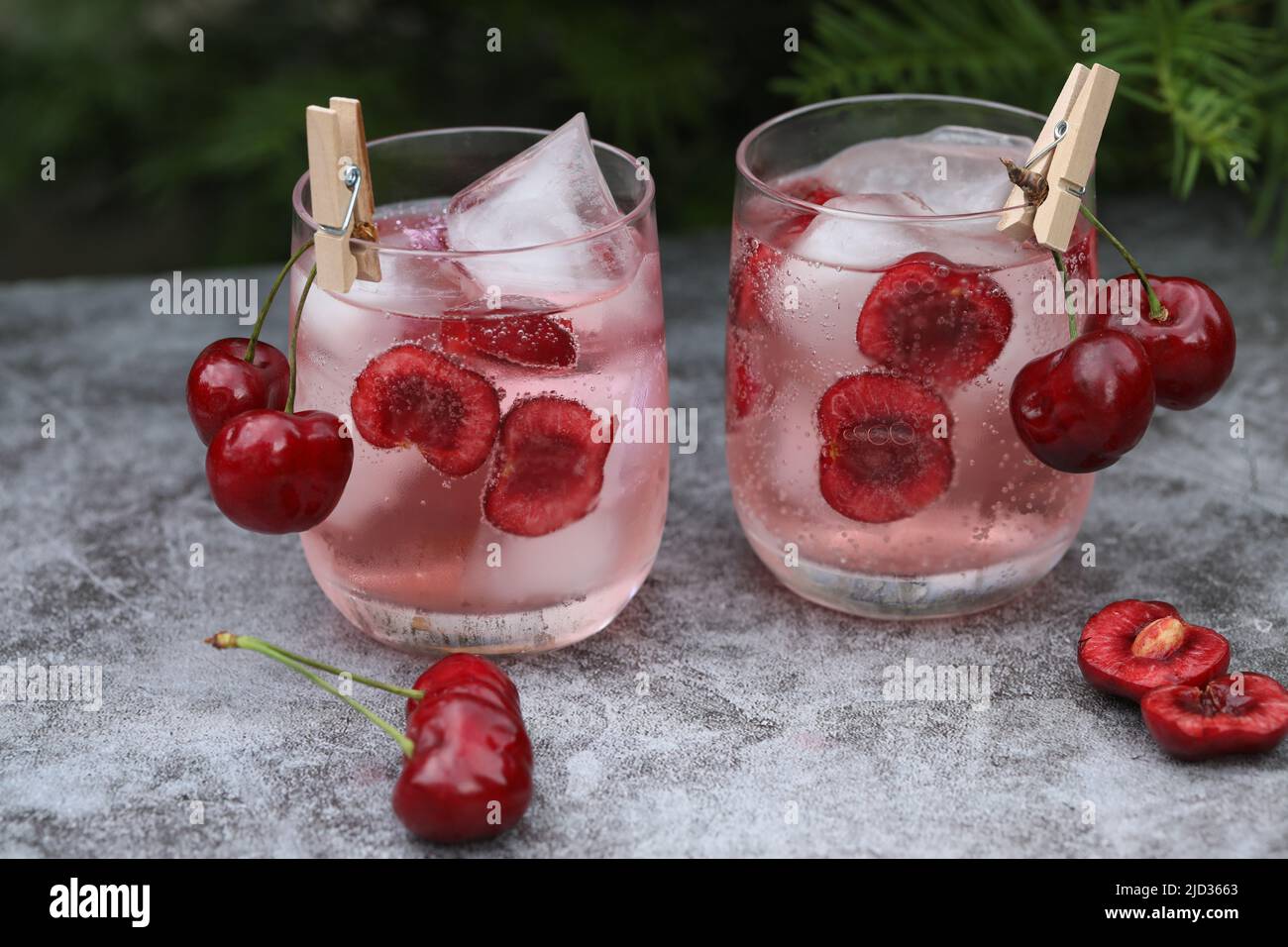 Glass of cold drink with sweet cherry Stock Photo - Alamy