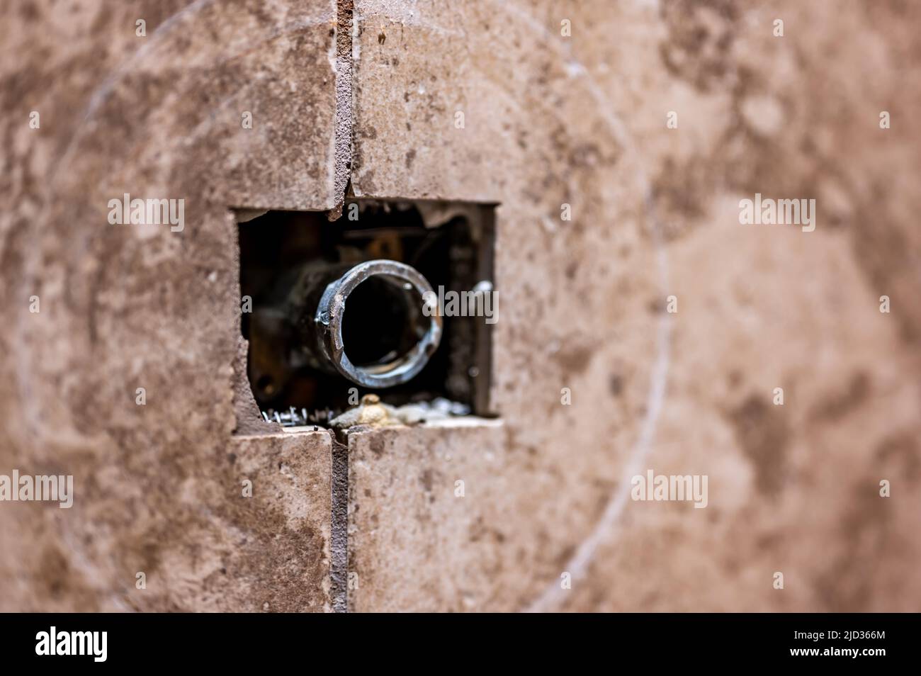Cut-out section in bathroom shower tile with pipe connection protruding ...