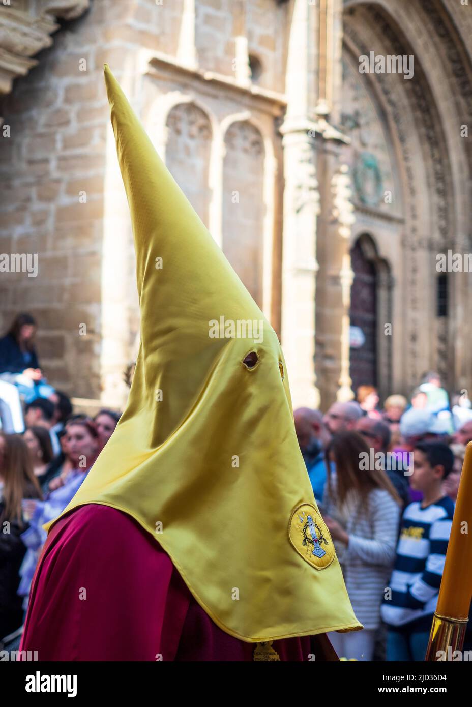 Cofrades in their traditional costumes with capirote, parading through ...