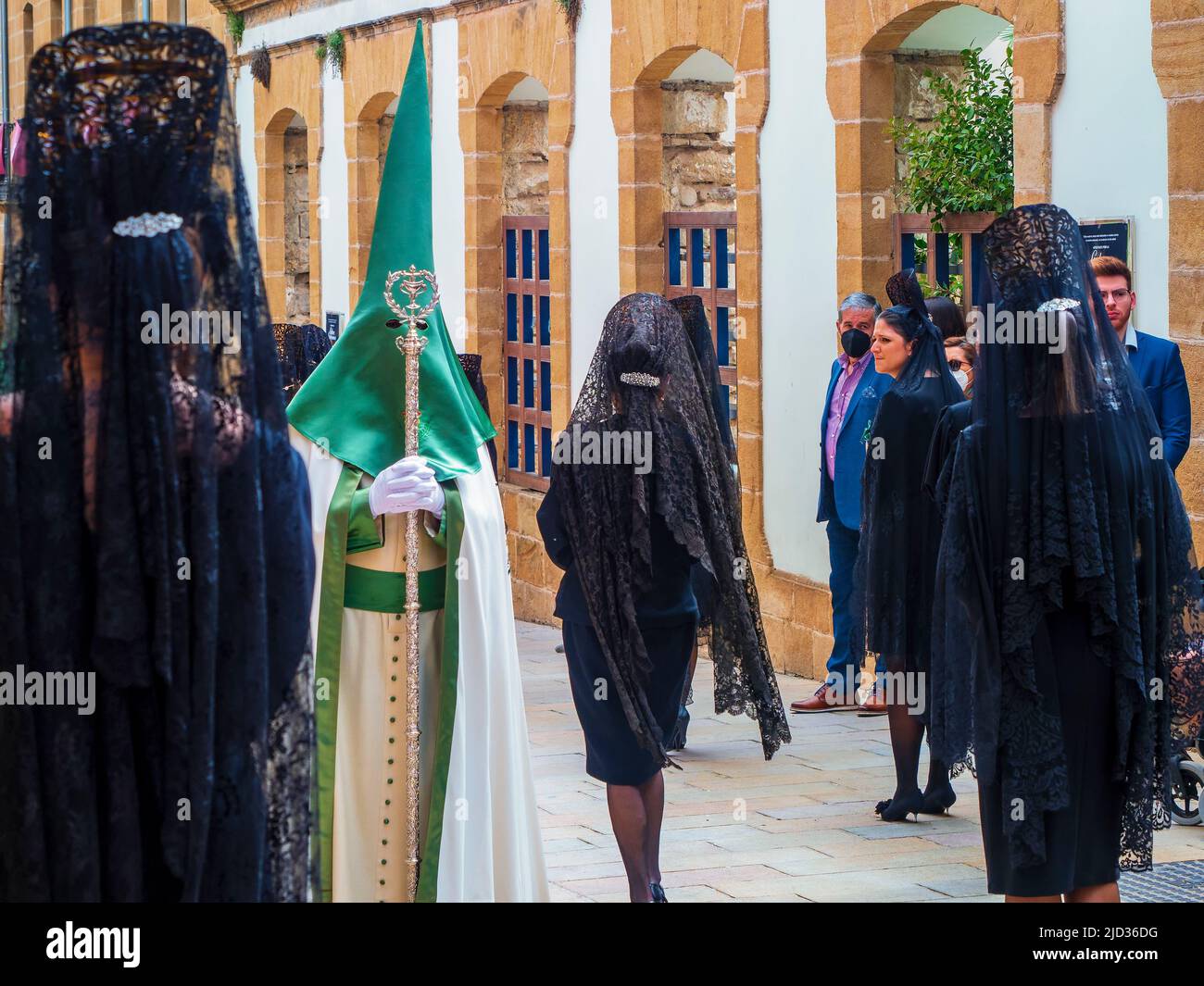 Women dressed in the traditional mantilla, parading through the streets ...