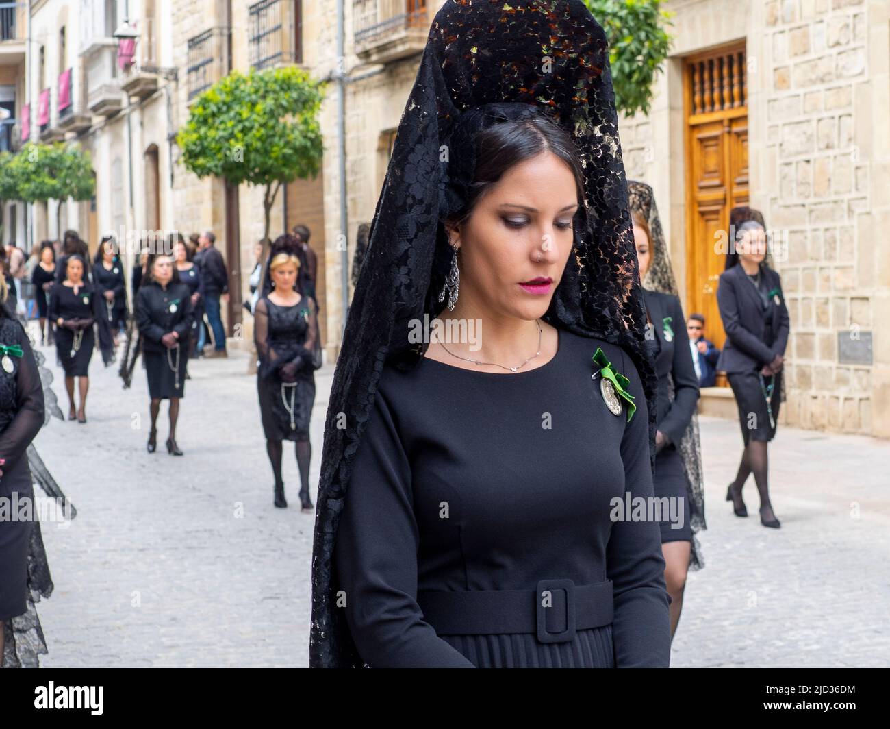 Women dressed in the traditional mantilla, parading through the streets ...