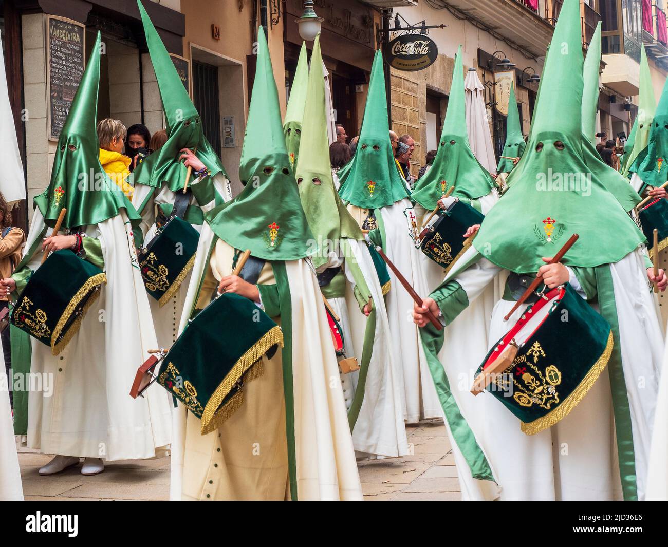 Cofrades in their traditional costumes with capirote, parading through ...