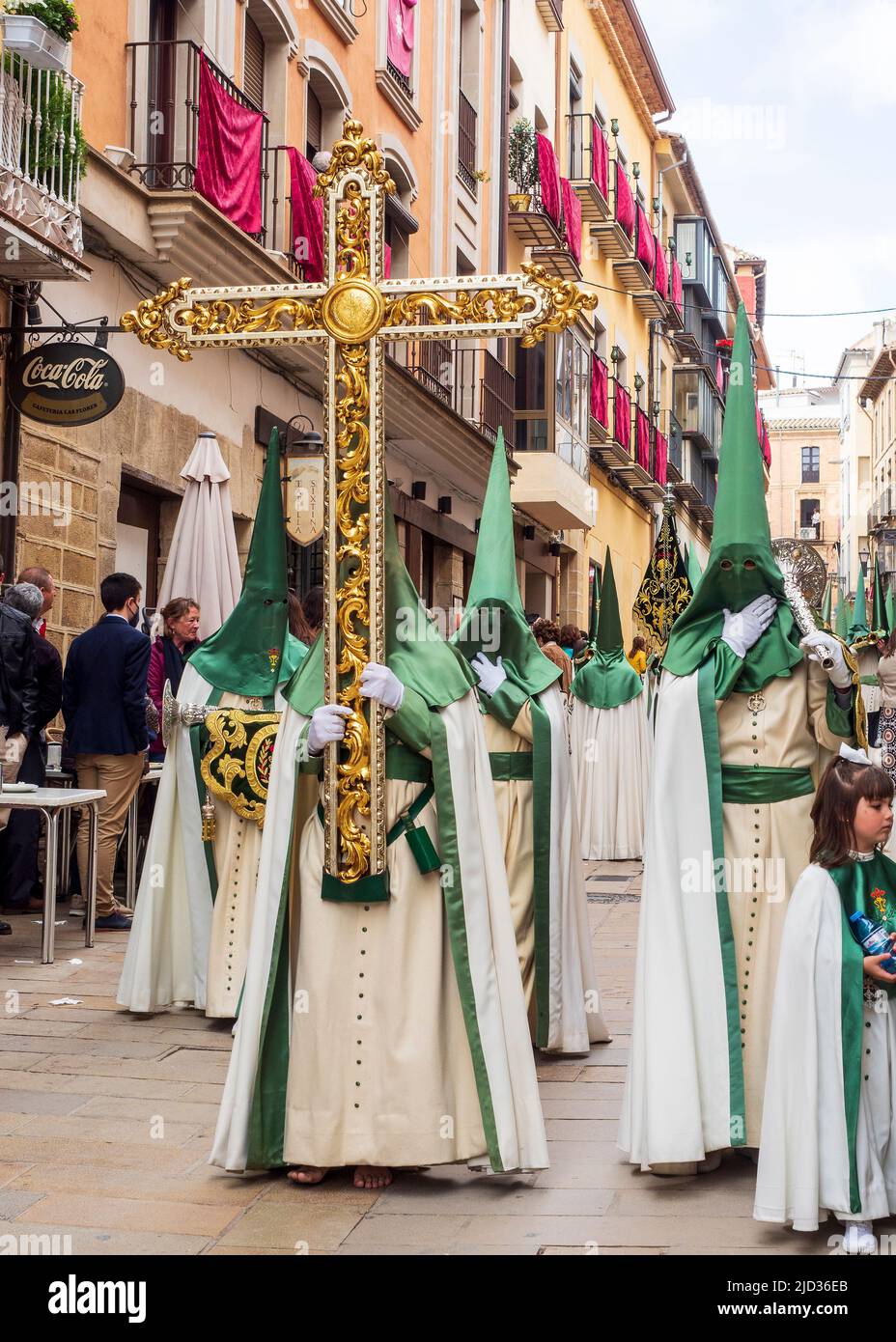 Cofrades in their traditional costumes with capirote, parading through ...