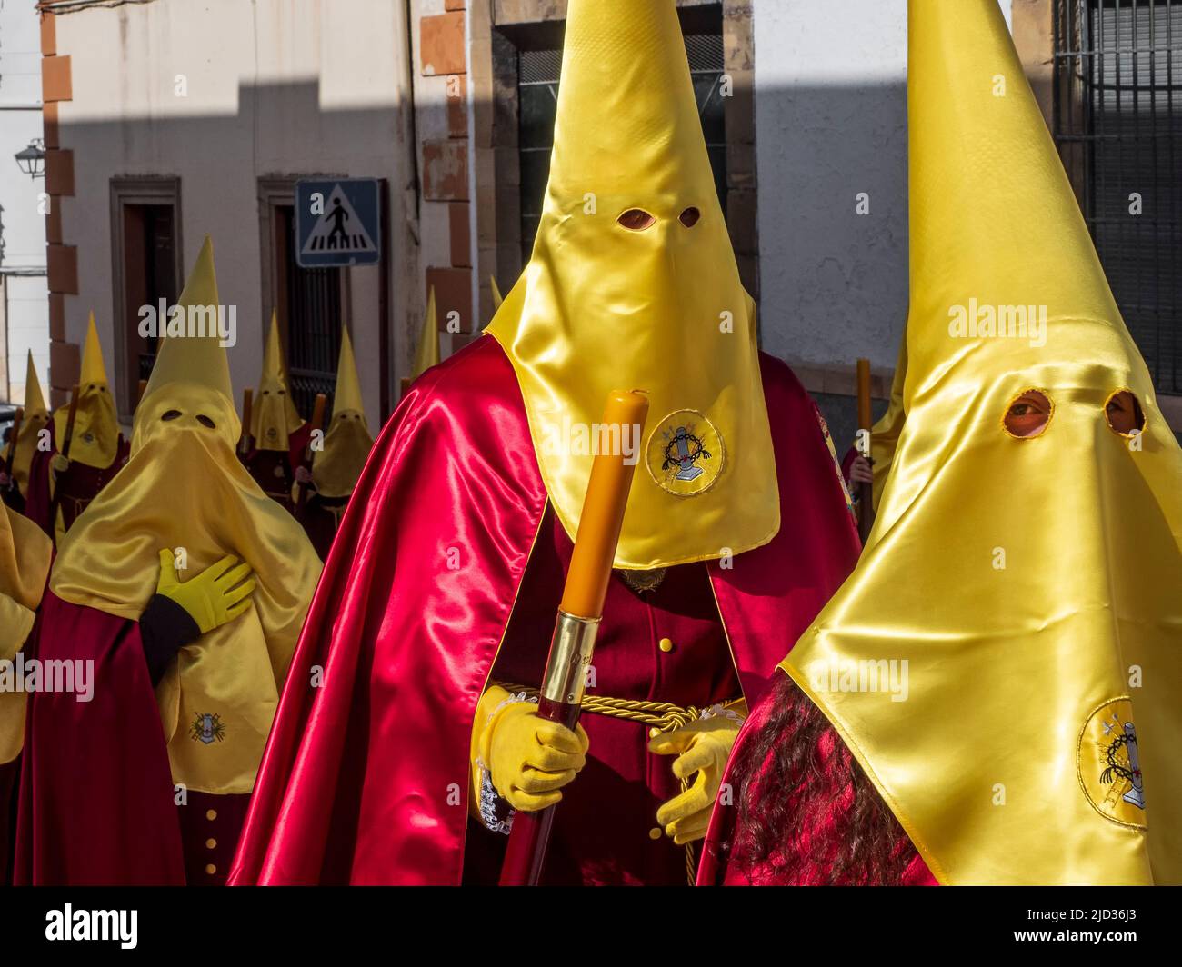 Cofrades in their traditional costumes with capirote, parading through ...