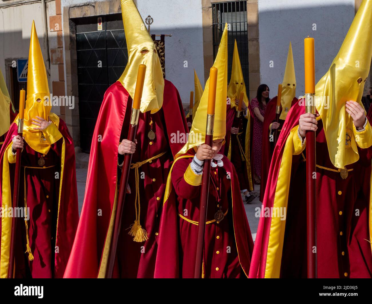 Cofrades in their traditional costumes with capirote, parading through ...