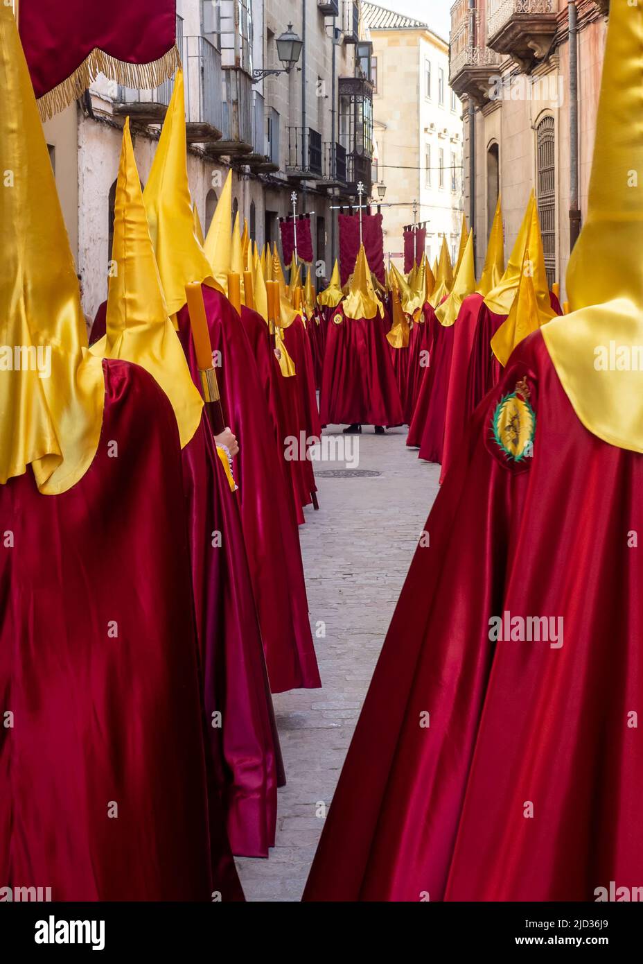Cofrades in their traditional costumes with capirote, parading through ...
