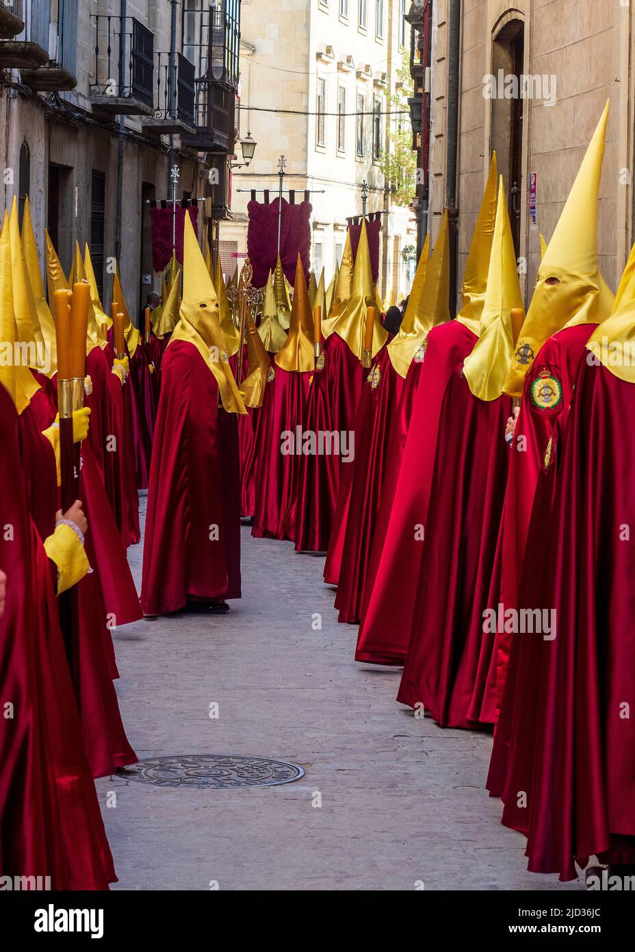 Cofrades in their traditional costumes with capirote, parading through ...