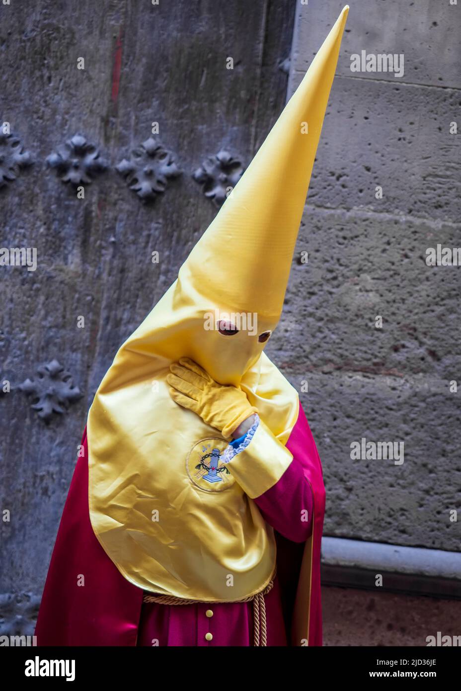 Cofrades in their traditional costumes with capirote, parading through ...