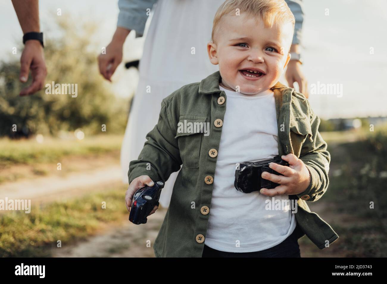 Funny Toddler Boy Holding Toys in Hands and Running Away from His ...