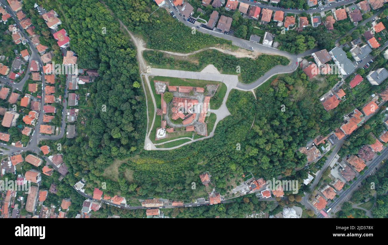 Drone top aerial view of Brasov town with parks and surrounding hills ...