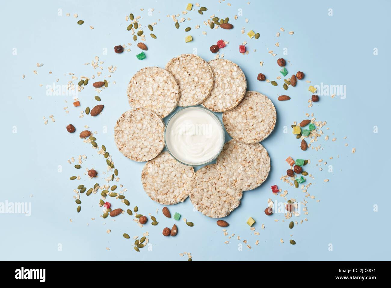 Stack of rice cakes, dried fruits and nuts on blue background. Healthy ...