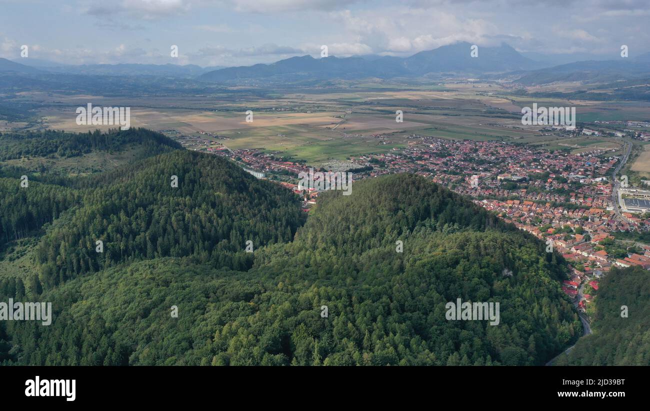 Aerial drone top view of Transylvania town and forests, hills and ...