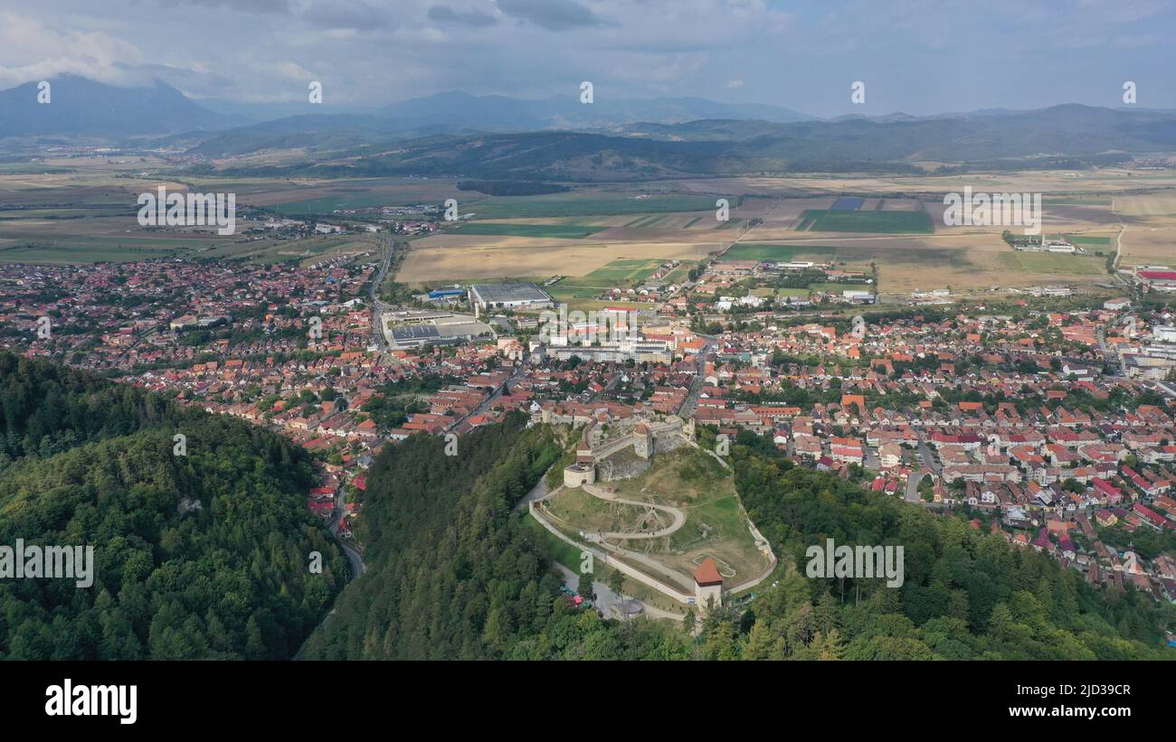Aerial drone top view of Transylvania town and forests, hills and ...