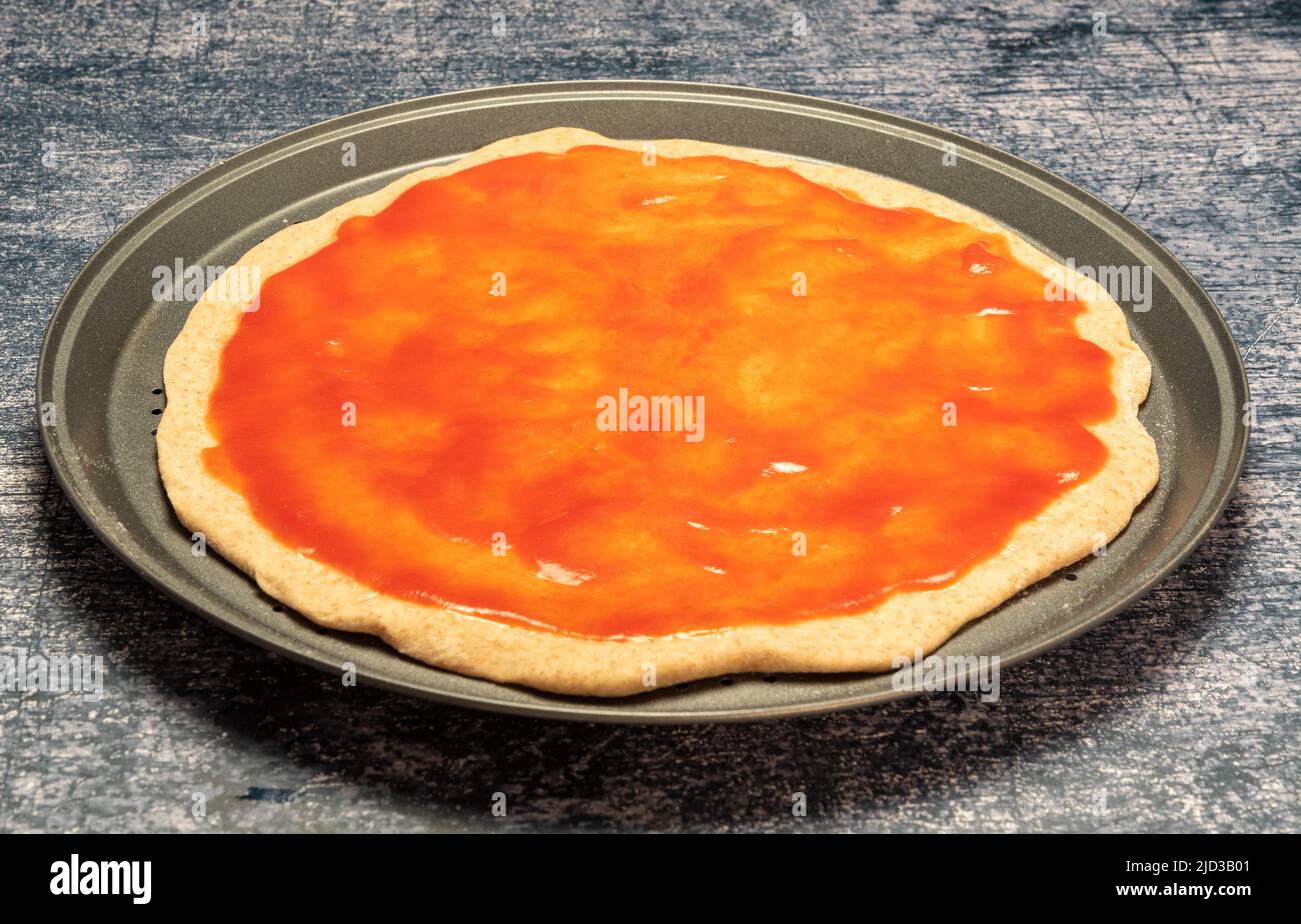 pizza base with tomato sauce Stock Photo - Alamy