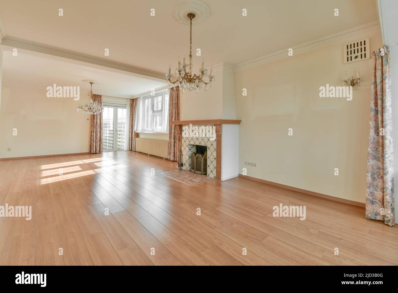 Spacious bright empty room with fireplace, panoramic windows and ...