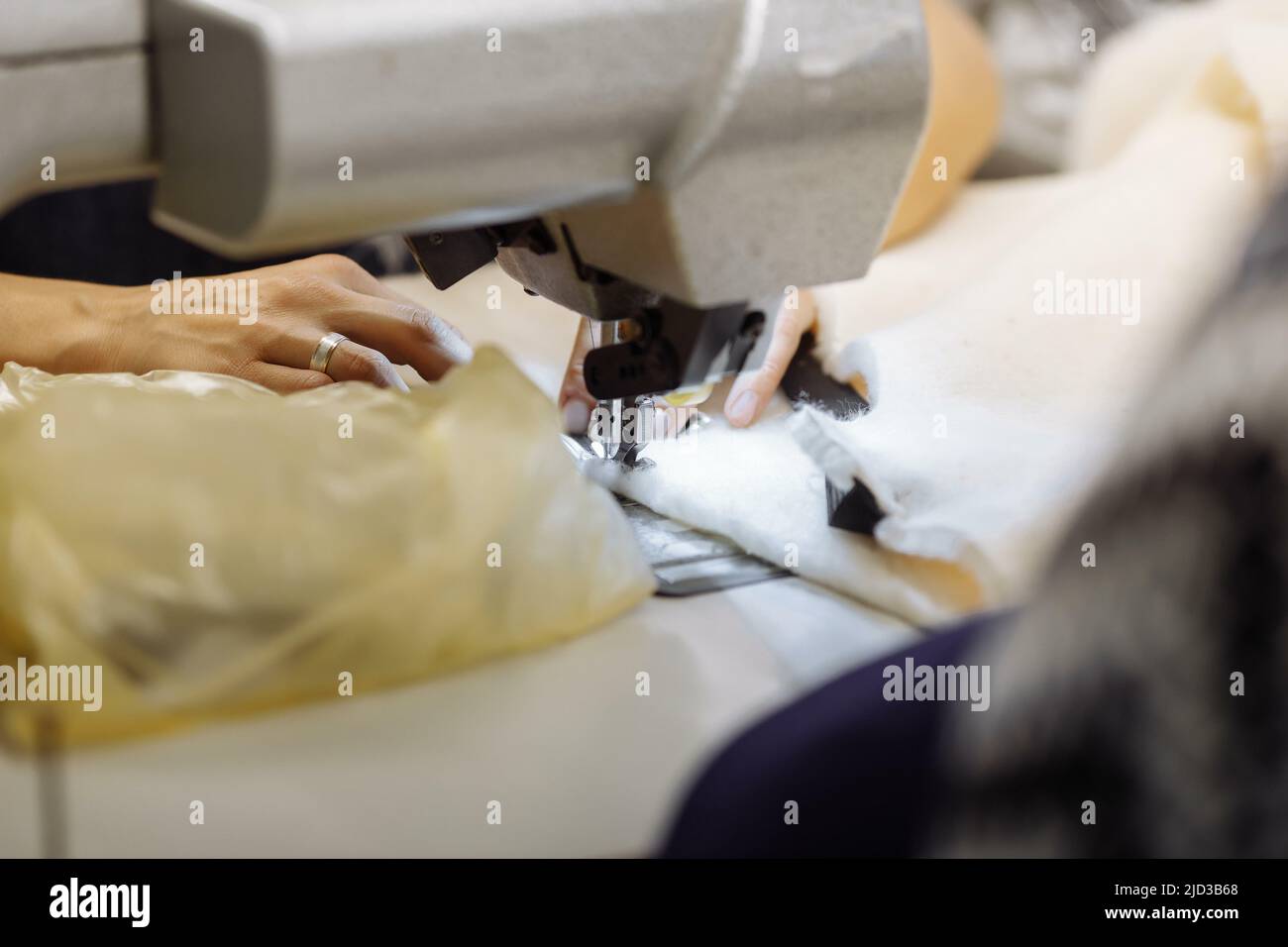 sewing machine scribbling fabric. tailoring at the factory Stock Photo ...