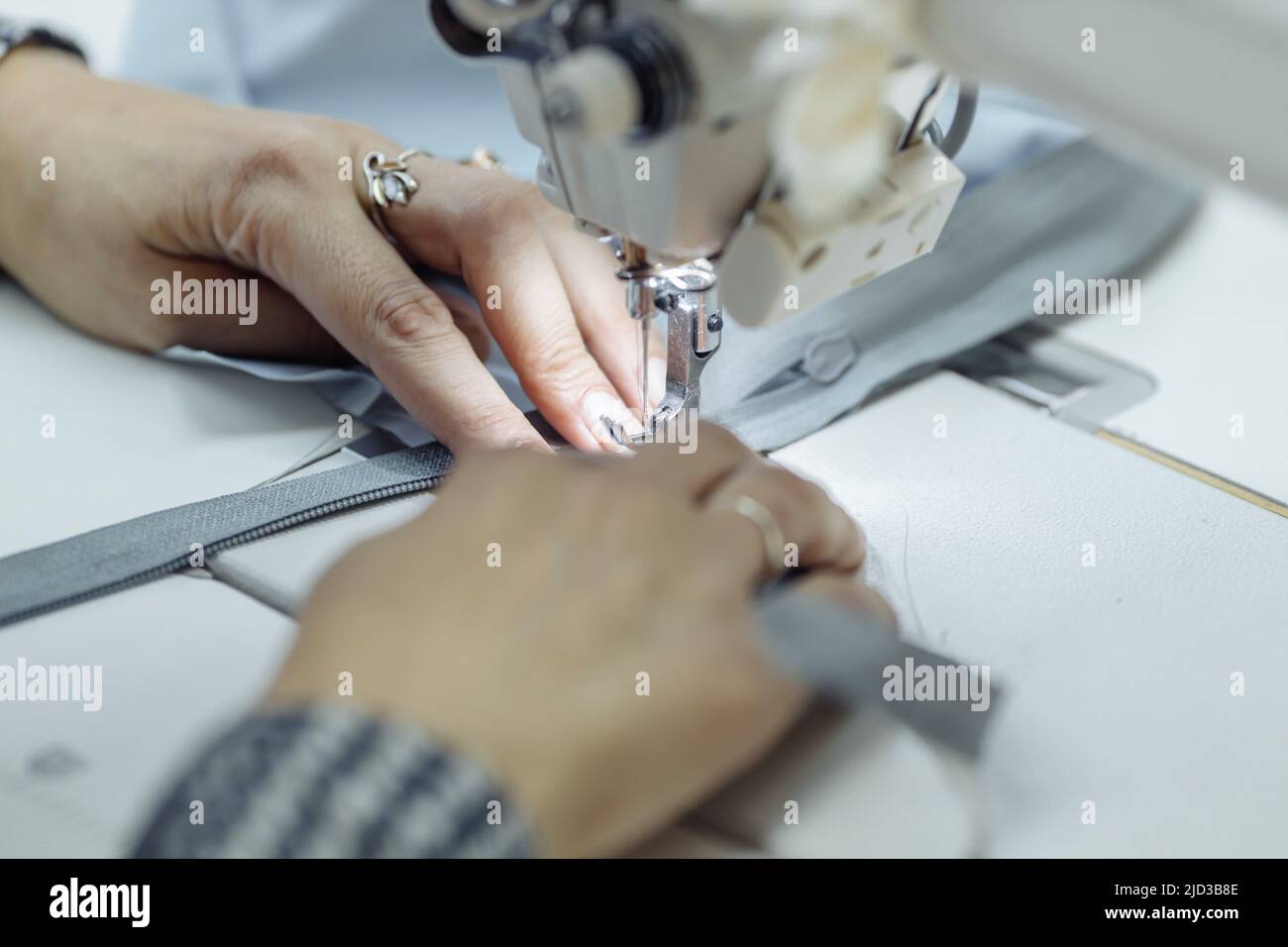 sewing machine scribbling fabric. tailoring at the factory Stock Photo ...