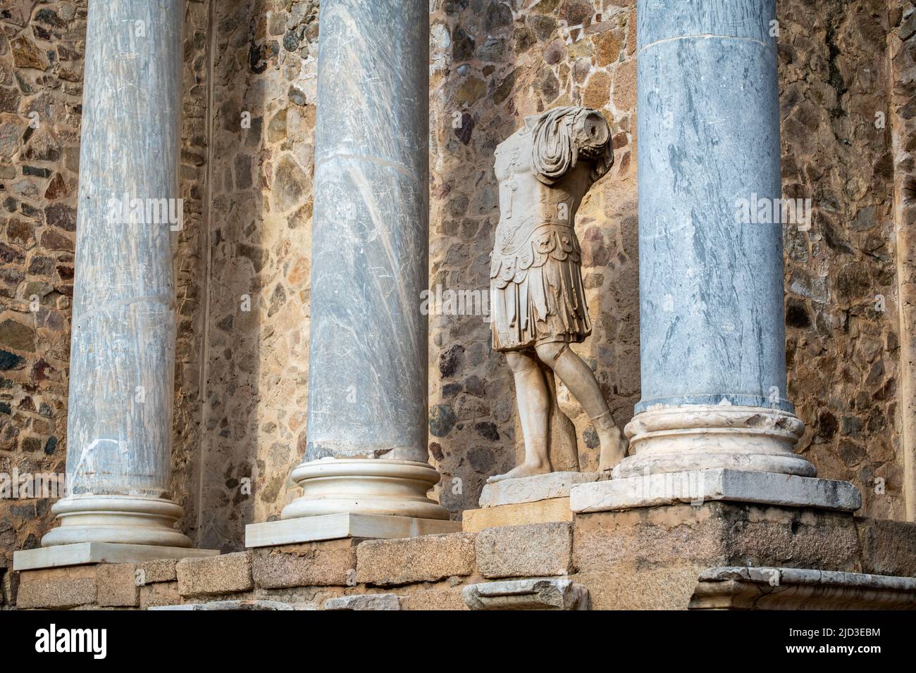 A statue amongst the columns of the Roman Theatre of Merida, Merida ...