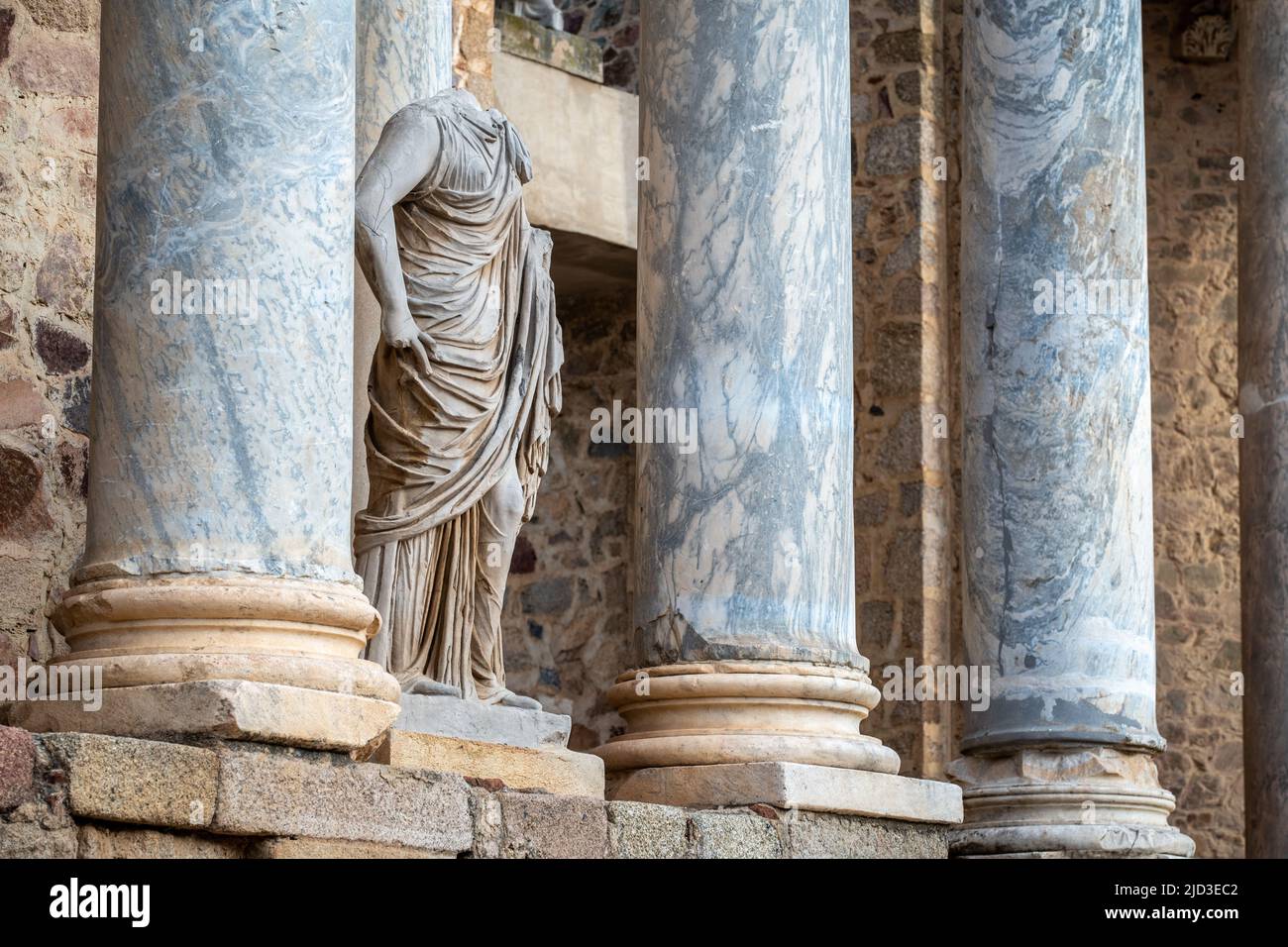 A statue amongst the columns of the Roman Theatre of Merida, Merida ...