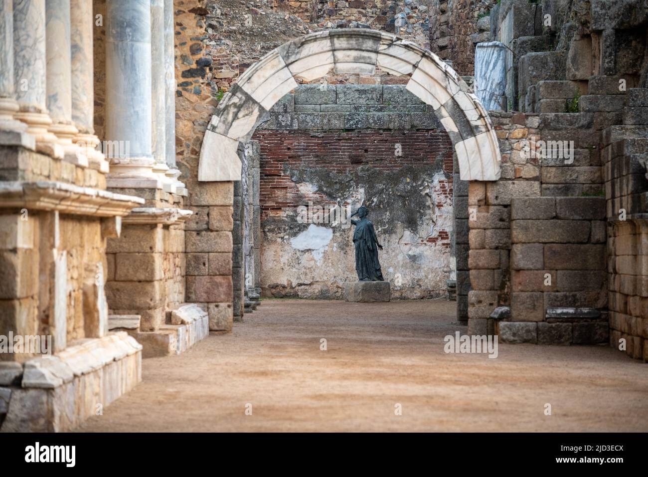 A statue seen through an archway in the Romand Theatre of Merida ...